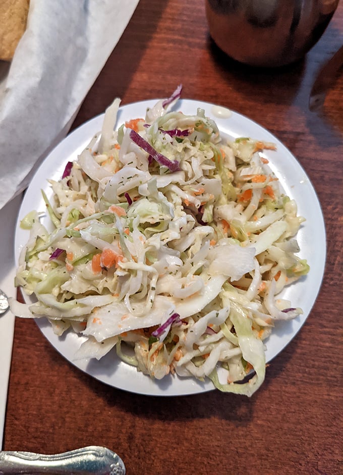 Classic coleslaw providing the crisp, tangy relief your palate craves between bites of smoky perfection.