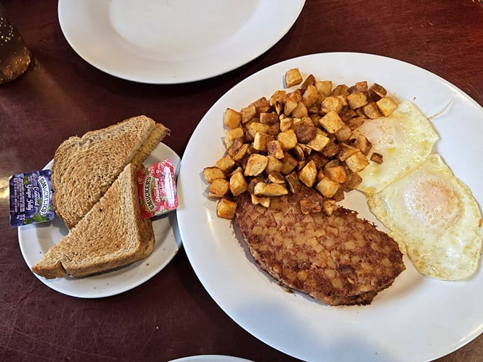 A classic diner breakfast with perfectly seasoned corned beef hash, eggs, and country potatoes—the holy trinity of morning satisfaction.