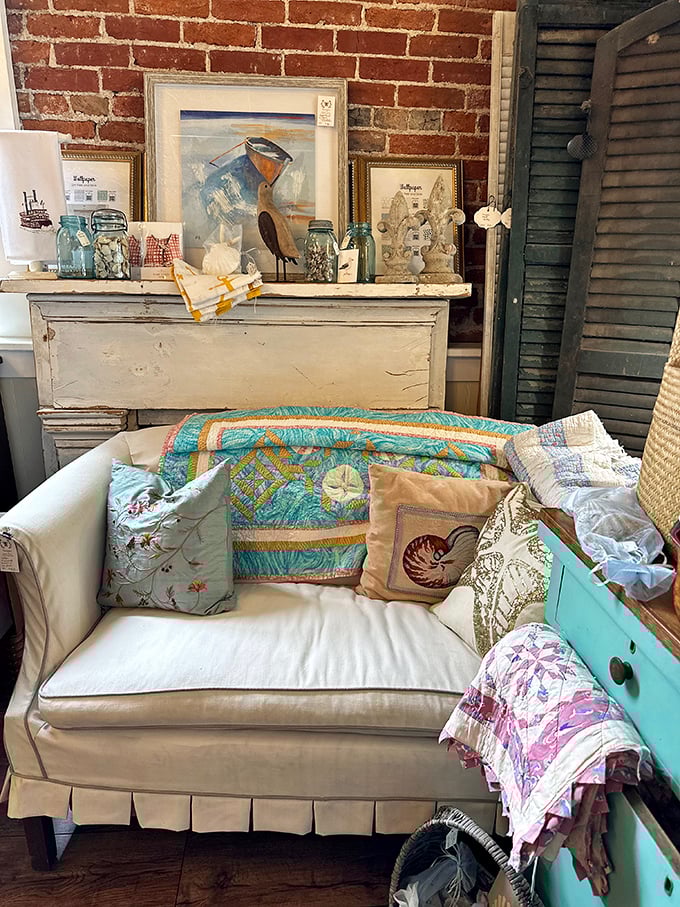 A perfectly staged vignette – the white sofa with coastal pillows whispers stories of summer homes and weekend getaways.