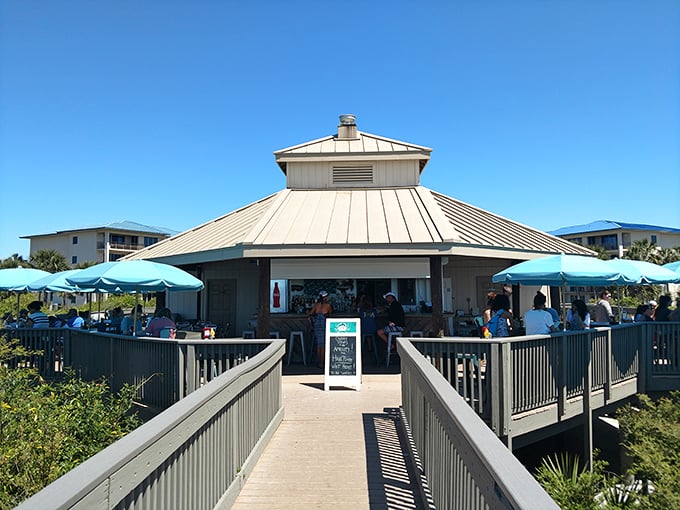 This beachside pavilion serves as the perfect halfway point between swimming and napping—a shaded oasis where salt air mingles with the scent of sunscreen and satisfaction.