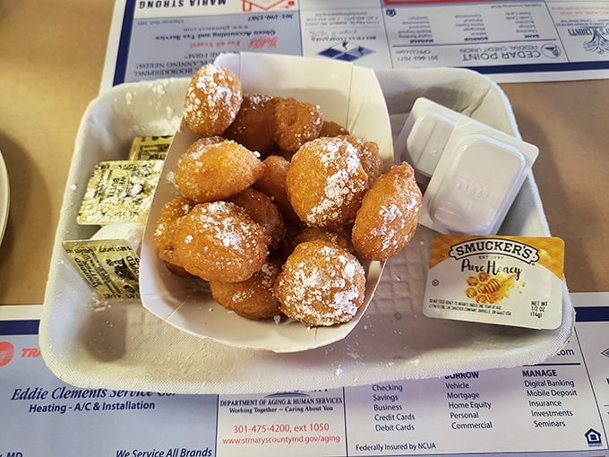 Golden hush puppies dusted with powdered sugar—a sweet Southern counterpoint to all that savory seafood. The perfect between-crab palate cleanser!