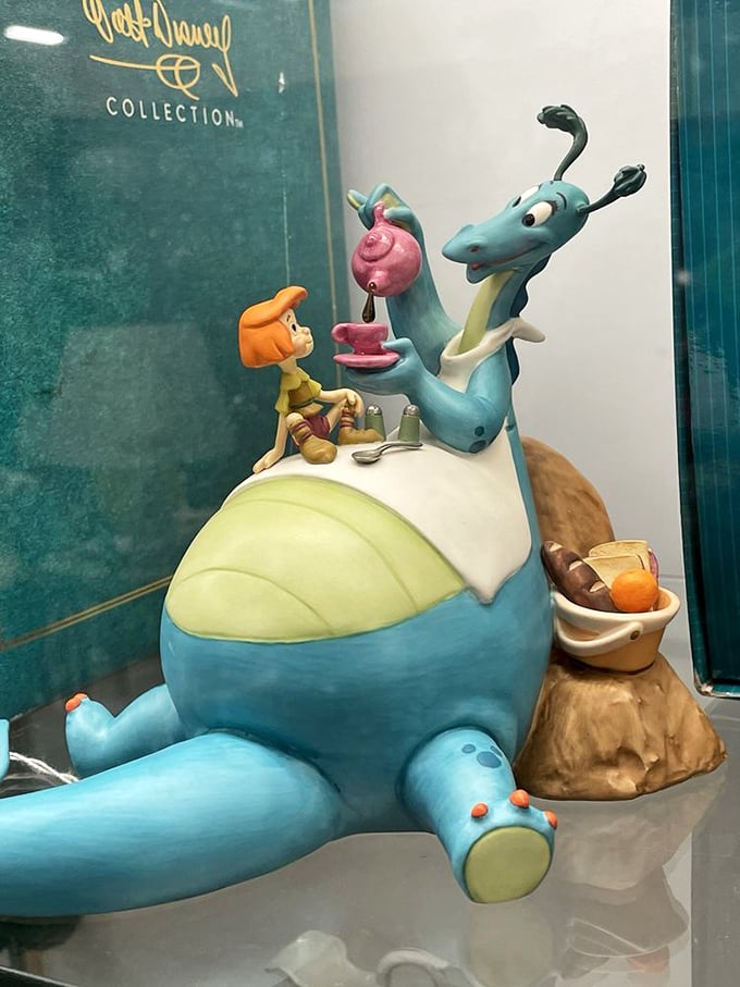 Disney magic captured in porcelain – this Walt Disney Collection figurine features characters from "The Reluctant Dragon," preserved behind protective glass.