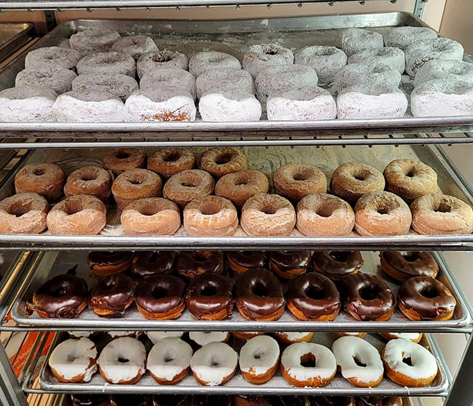 The donut display case showcases a United Nations of fried dough—from powdered ambassadors to chocolate-glazed diplomats negotiating peace with your diet.