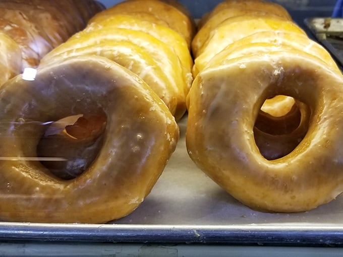 These golden glazed donuts aren't just breakfast—they're edible sunshine with a hole in the middle.
