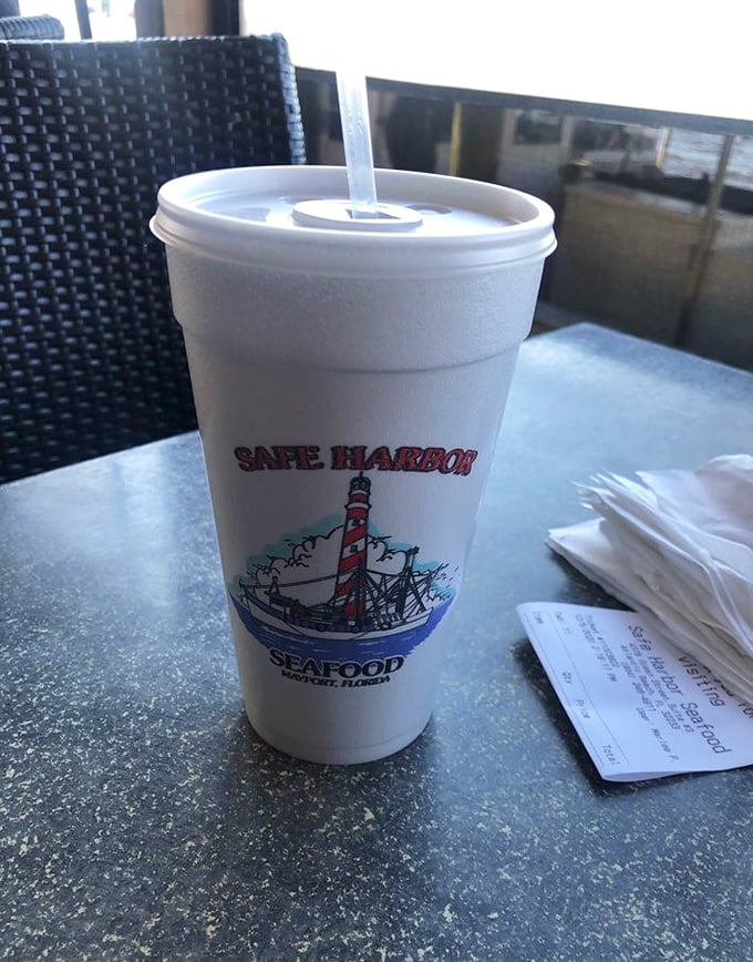 Even the cups tell a story here – a lighthouse logo reminding you that fresh seafood and coastal living go hand in hand.