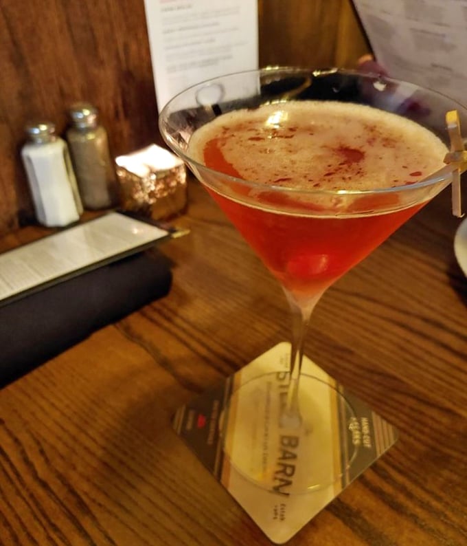 This isn't just a cocktail; it's liquid ruby in a glass, promising conversations that flow as smoothly as the spirits within.