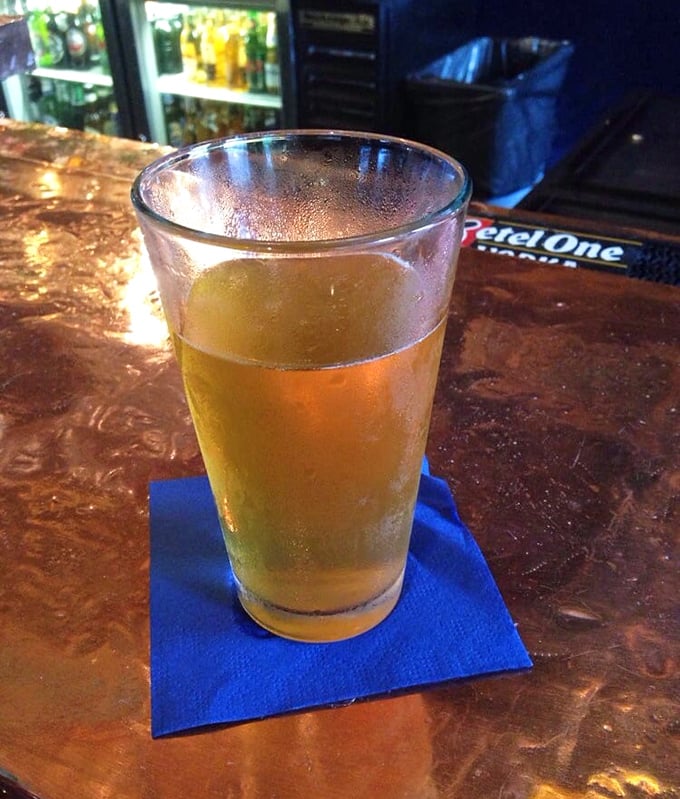 Sometimes the simplest pleasures are best—a cold beer on a blue napkin at a bar that feels like it's been waiting for you all day.