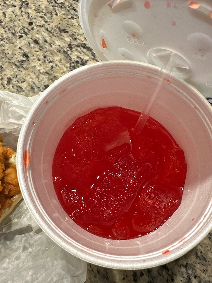 Even the drinks come with a side of nostalgia. That ruby-red sweetness in a plastic cup is the perfect counterpoint to the savory seafood.
