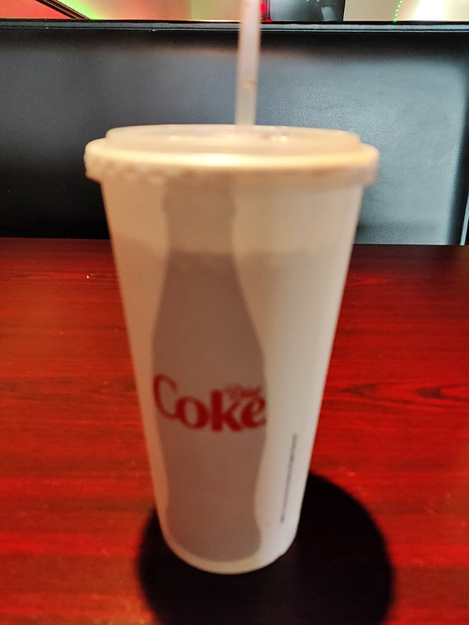 The classic fountain Coke—because sometimes the perfect pizza pairing isn't wine but a properly calibrated soda machine's handiwork.
