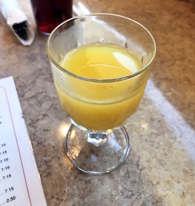 Fresh orange juice served in an actual glass goblet—because at Charlie's, even the small details deserve a touch of class. 