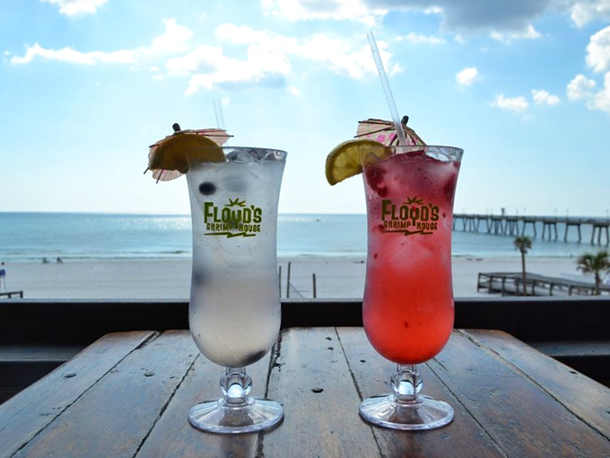 Colorful cocktails with tiny umbrellas against a Gulf backdrop – because nothing says "I'm on vacation" quite like drinking from glassware taller than your face.
