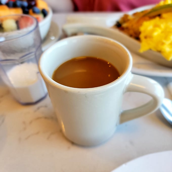 Coffee in a classic white mug—the unsung hero of every diner experience, silently fueling conversations and curing what ails you.