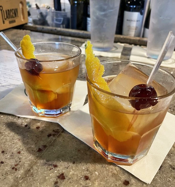 Old Fashioneds that would make Don Draper weep with joy—garnished with cherries that have clearly lived their best life. 