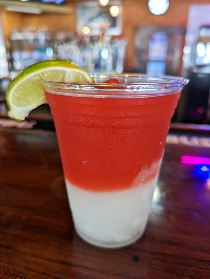 That two-toned tropical drink isn't just Instagram bait—it's liquid vacation with a lime wedge passport.