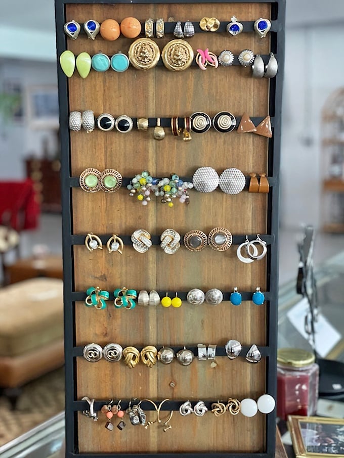 Jewelry display that would make a magpie jealous – vintage-inspired earrings and statement pieces waiting to become conversation starters at your next gathering.