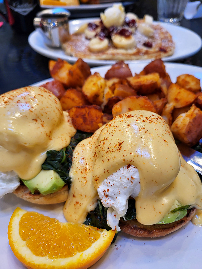 Eggs Benedict reimagined with avocado and spinach – proof that even classics deserve a Portland-style makeover occasionally.