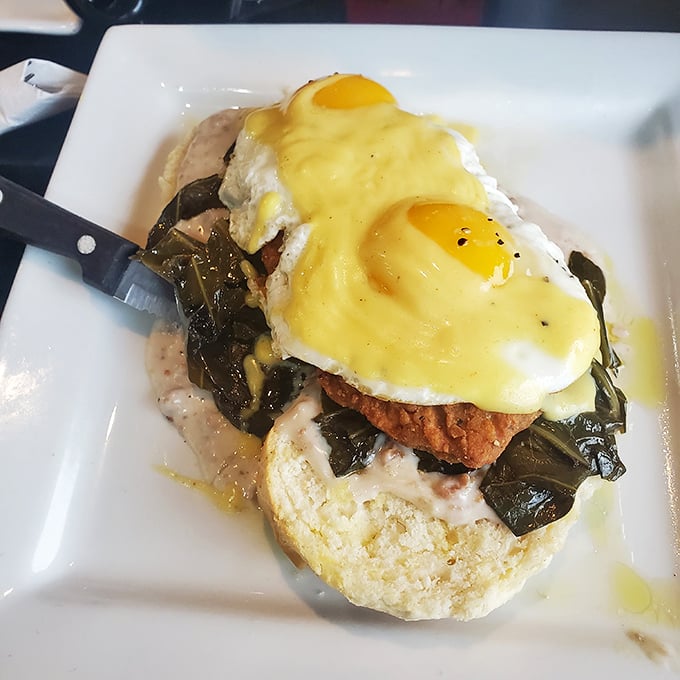 This Benedict isn't just breakfast—it's architecture. Perfectly poached eggs perched atop collards and what appears to be fried chicken create a Southern masterpiece.