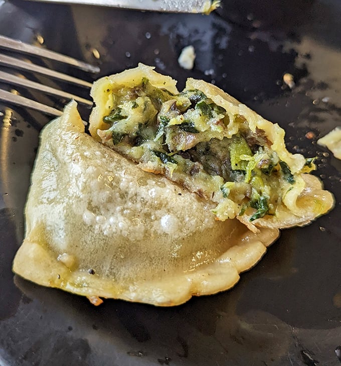 Cut open to reveal its secrets—this pierogi shows off a vibrant filling that's practically winking at you.