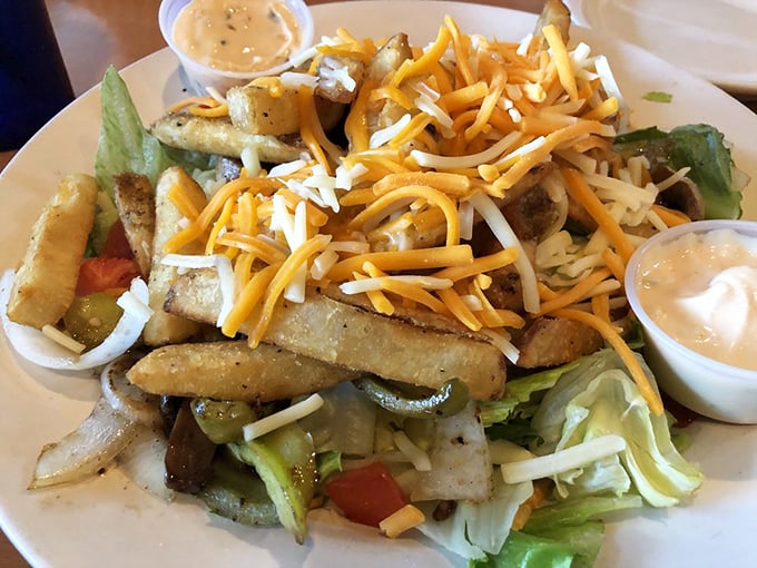 The Fire Pit Salad—where "eating healthy" and "indulging" somehow coexist in perfect harmony. Those fries aren't garnish; they're essential participants in this leafy party.