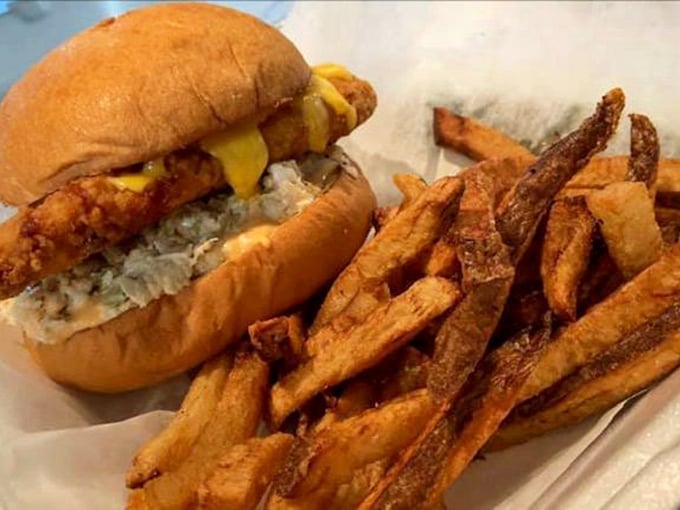 This isn't just a sandwich; it's edible architecture—crispy golden fish, melty cheese, and fries that deserve their own fan club.