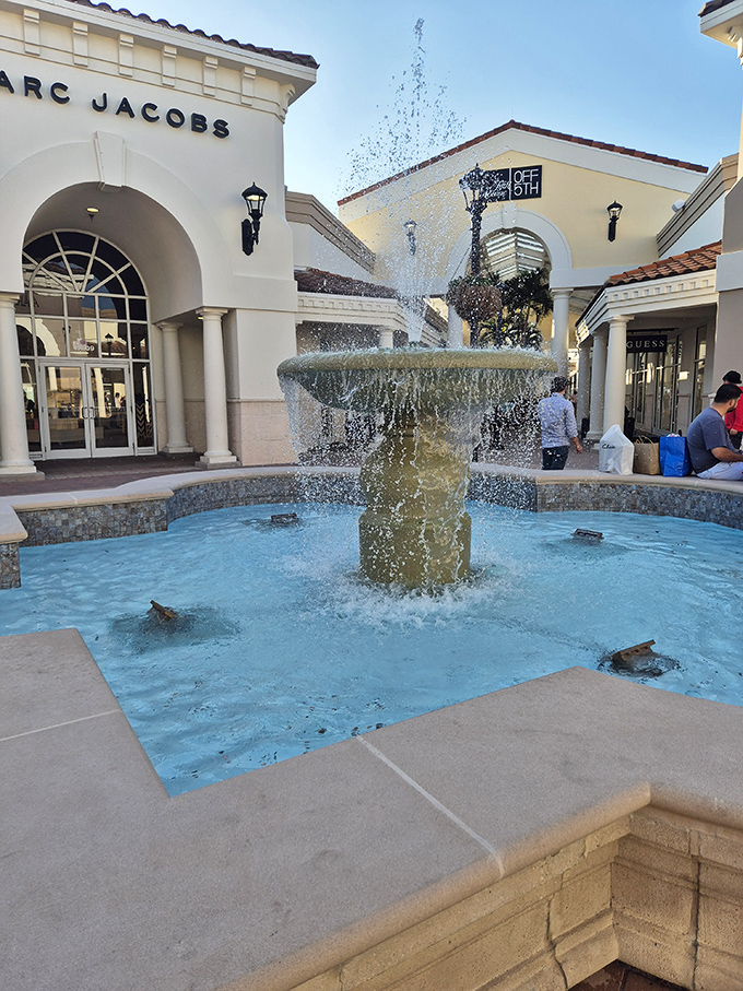 The fountain creates an oasis of calm amid shopping excitement, with Marc Jacobs and Off 5th providing the perfect backdrop for a moment's reflection.