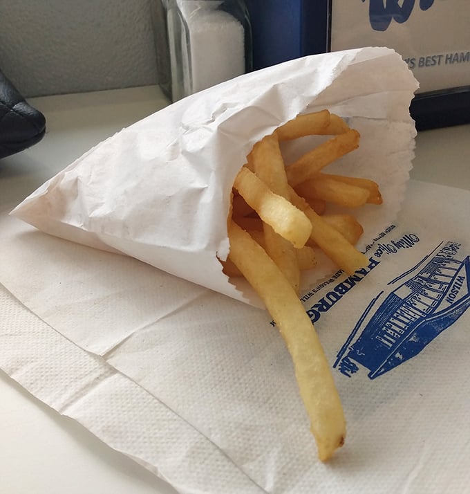 These fries aren't just side characters in your meal's story—they're scene-stealers wrapped in paper like precious golden treasures.