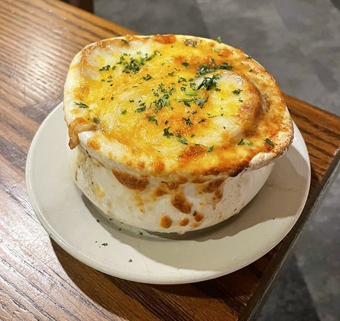 This isn't just French onion soup—it's a cheese-crowned masterpiece. Breaking through that golden dome feels like discovering buried treasure. 