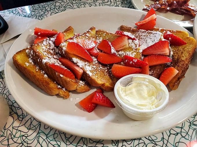 French toast that makes ordinary bread feel inadequate. Those strawberries aren't just garnish—they're jewelry for a breakfast worthy of royalty.