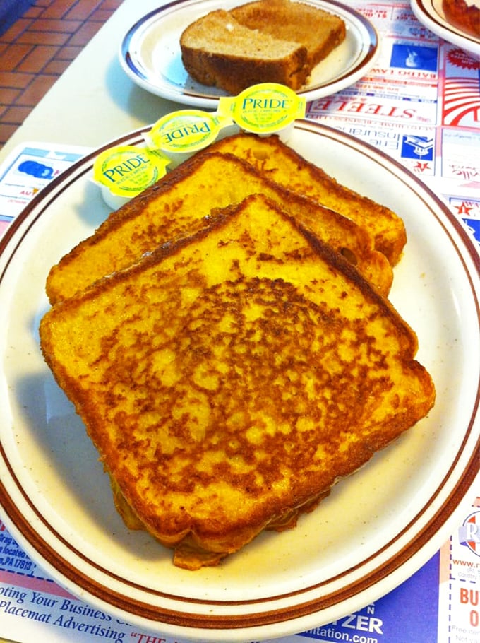 French toast so perfectly golden it belongs in a museum, though it's much better appreciated on your plate with those little butter packets standing by.