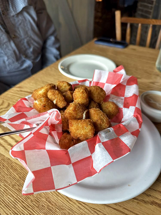 Golden-fried cheese curds nestled in a checkered basket—crispy on the outside, melty on the inside, and gone in sixty seconds.