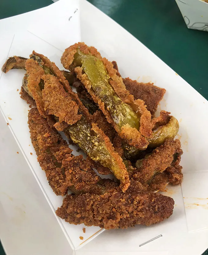 Fried pickles with that perfect crunch-to-tang ratio – the supporting actor that sometimes steals the scene from the headlining sandwich.