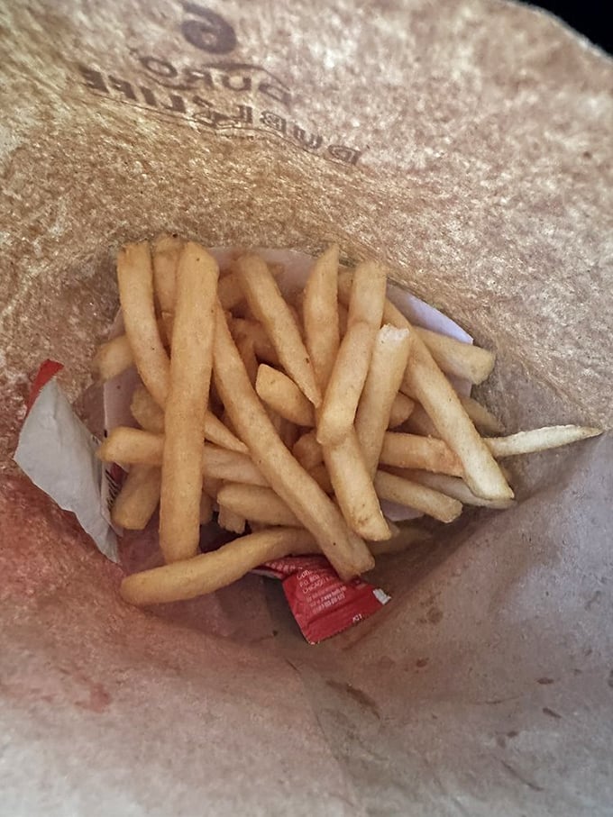 French fries nestled in their paper nest. Crispy on the outside, fluffy inside—the supporting actors that sometimes steal the show.