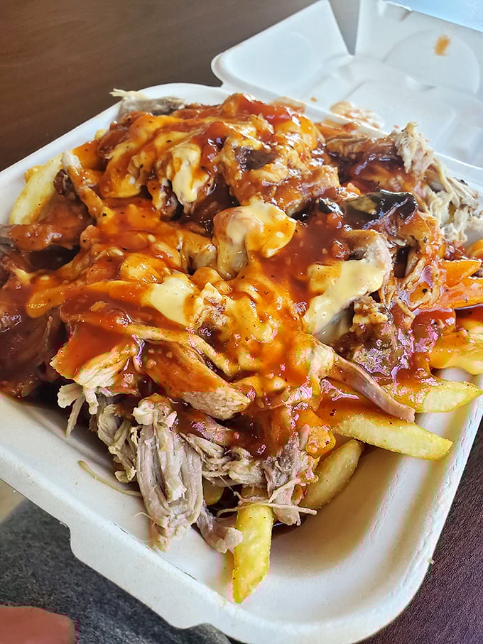 Pulled pork fries smothered in cheese and sauce—because sometimes your inner child and sophisticated adult palate need to high-five each other.