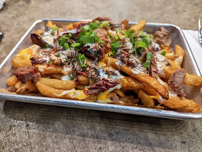 Loaded fries that blur the line between side dish and main event – a golden, cheese-draped canvas for smoky meat masterpieces.