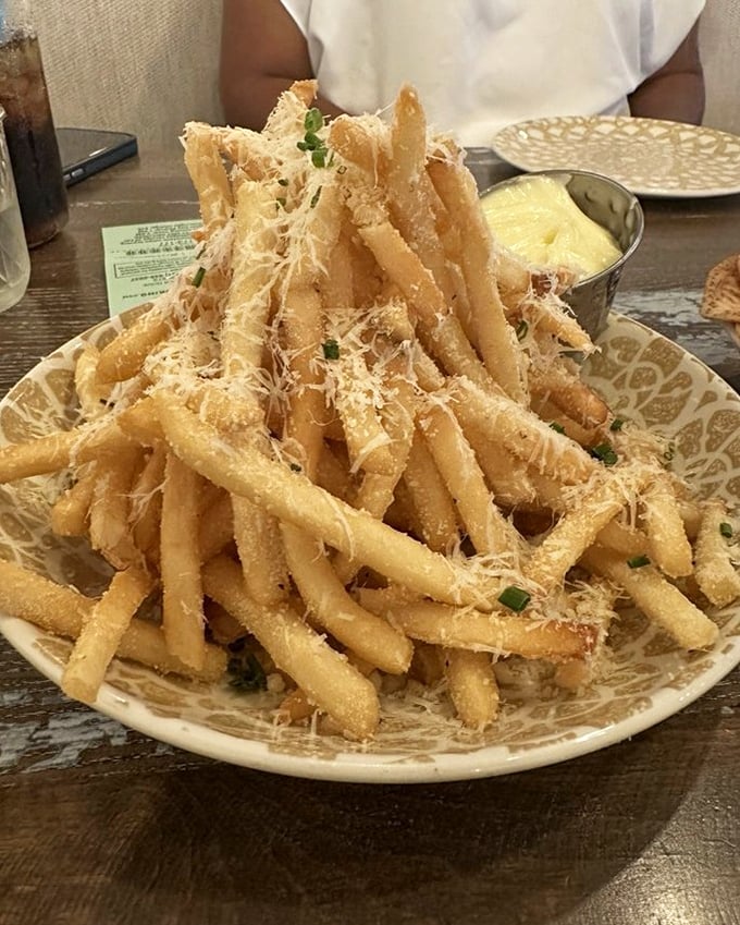 Parmesan truffle fries stacked like a golden tower of crispy, cheesy magnificence—the side dish that frequently steals the spotlight.