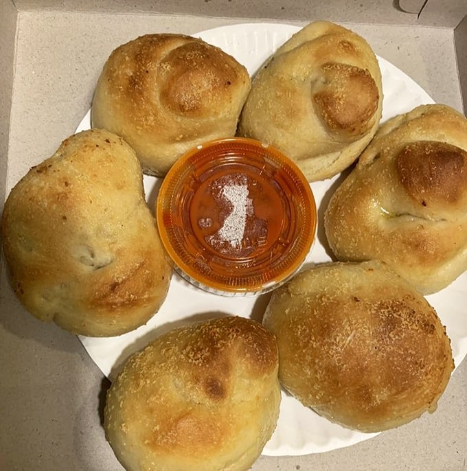 These garlic knots arrive like edible jewelry, each one a perfectly twisted testament to carbohydrate craftsmanship.