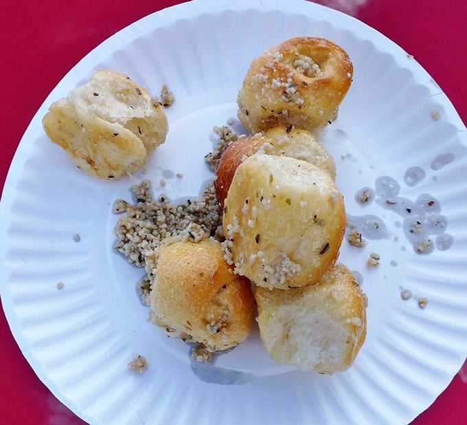 These garlic rolls aren't just side dishes – they're little pillowy miracles that could start religions. Garlicky, buttery, and absolutely worth the breath mints.