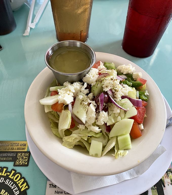 A Greek salad that actually looks like vegetables, not an afterthought. That feta isn't shy – it's the star of the show.