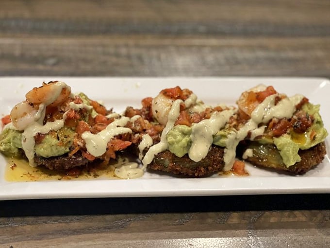 These aren't just fried green tomatoes – they're Southern tradition transformed into bite-sized treasures topped with seafood and avocado.