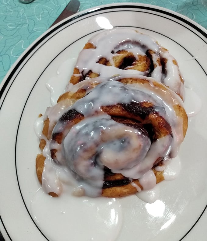 This isn't just any cinnamon roll—it's been kissed by the grill and smothered in icing that melts into every warm, cinnamon-scented crevice.