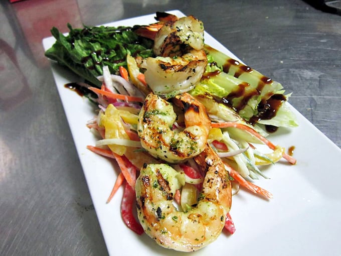These grilled shrimp haven't just been cooked—they've been respected, nestled atop a rainbow of vegetables that crunch with each bite.