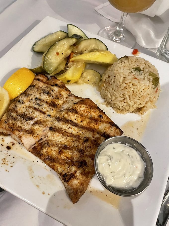Grilled mahi-mahi that's actually moist—a Florida miracle—served with seasonal vegetables and rice that's absorbed just enough flavor to be interesting on its own.