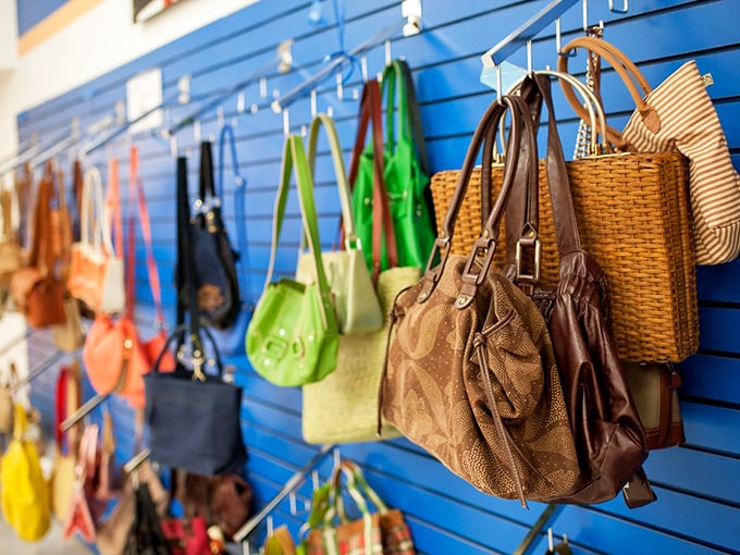 Handbag heaven on a blue wall—from practical totes to statement pieces. That woven basket bag is practically begging for a farmers market adventure.