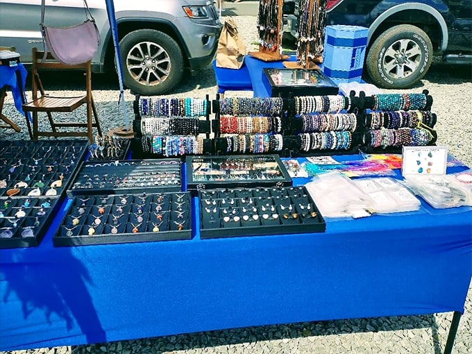 Jewelry that tells stories! Each handcrafted bracelet and necklace on this vibrant blue display represents hours of craftsmanship and imagination.