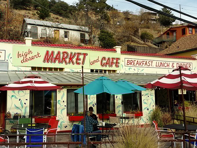 High Desert Market and Cafe offers shaded respite and locally-sourced delights. Those red umbrellas aren't just for show—they're beacons for hungry explorers navigating Bisbee's vertical landscape. 
