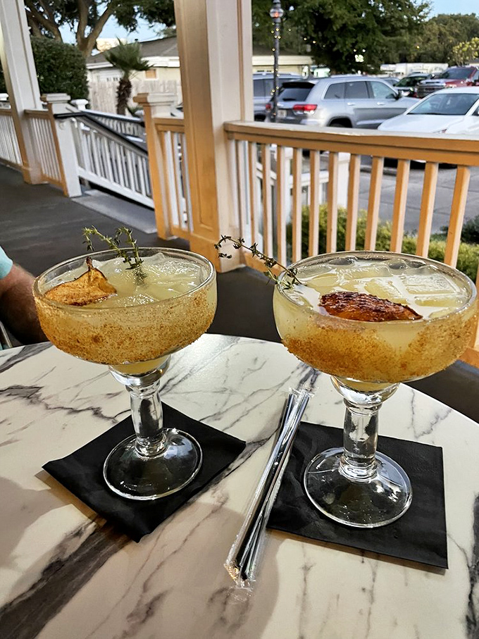 Cocktails on the porch – where Florida's sunshine gets transformed into liquid gold, garnished with herbs that look like they were picked minutes ago.