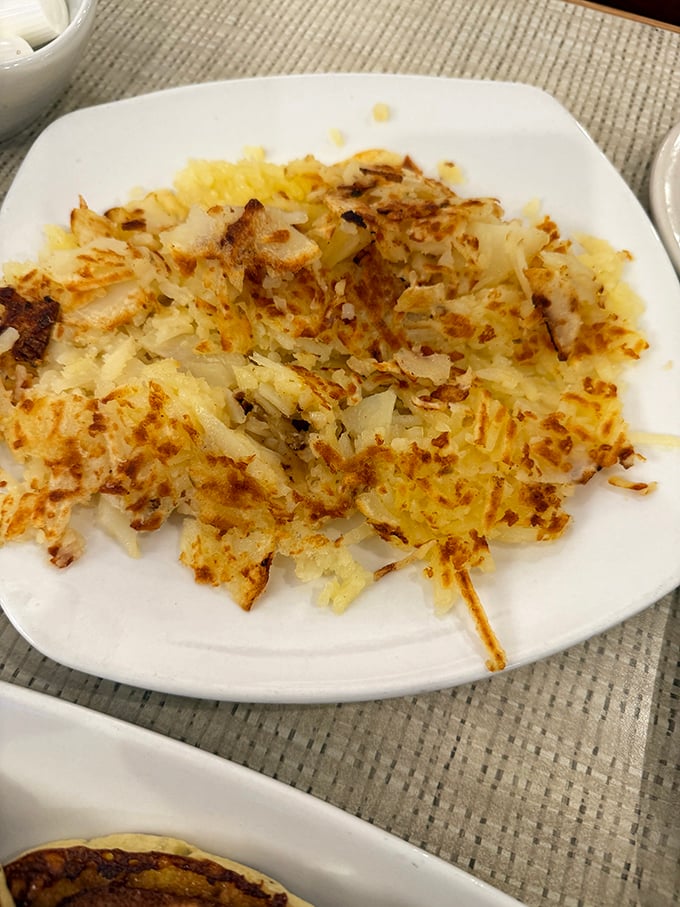 These hash browns achieved the impossible dream – crispy exterior, tender interior, and enough golden-brown goodness to make a potato proud of its life choices.