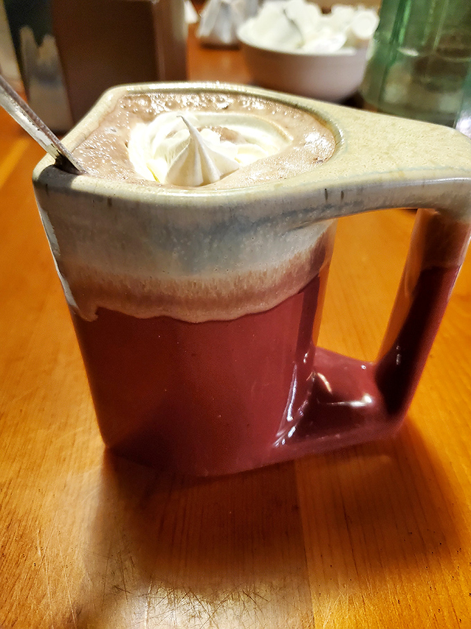 Hot chocolate that makes Swiss chocolatiers nervous. That dollop of whipped cream isn't floating – it's performing a trust fall into heaven.