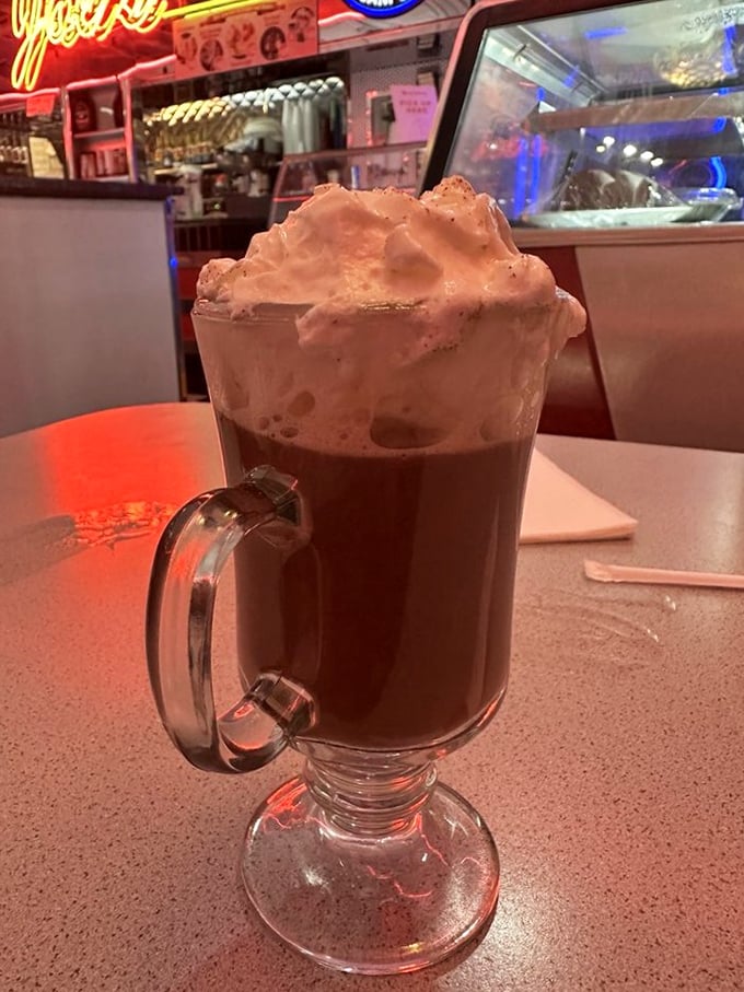 Hot chocolate that doesn't know when to quit – topped with a cloud of whipped cream that makes Swiss Alps look like speed bumps.