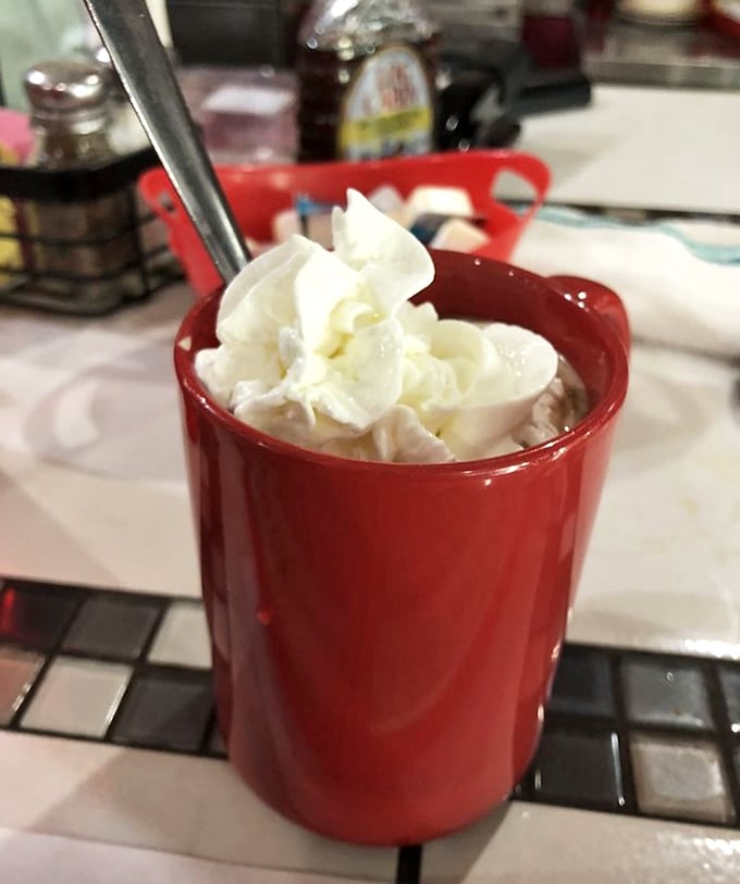 Hot chocolate that doesn't know it's in Florida – topped with a cloud of whipped cream in a mug as red as your future food cravings.